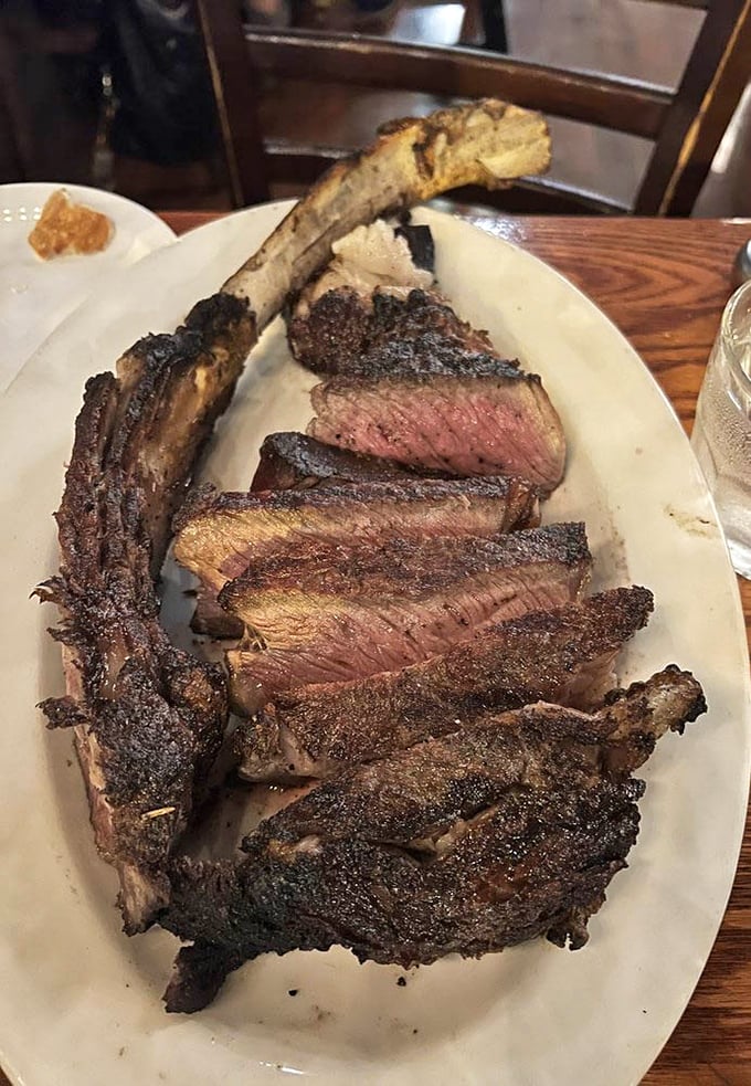 This tomahawk steak isn't just dinner – it's performance art with protein. The perfectly charred exterior gives way to a blushing pink center that would make Michelangelo weep.