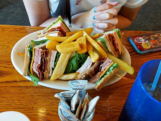 Behold the legendary Turkey Club—architectural marvel, flavor symphony, and the reason some folks drive across three counties just for lunch.