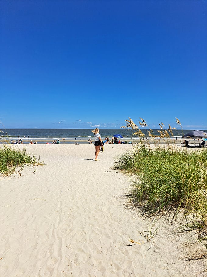 Sandy pathways flanked by sea oats lead to paradise. The anticipation builds with every step toward that endless horizon.