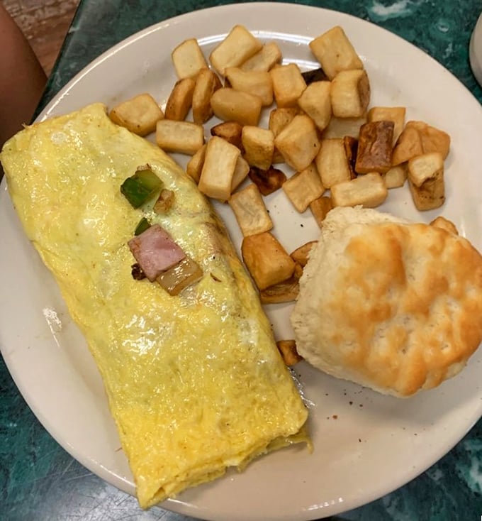 This Western omelet doesn't just whisper "good morning"—it belts it out like Aretha Franklin, with home fries that could make a potato farmer weep with joy.