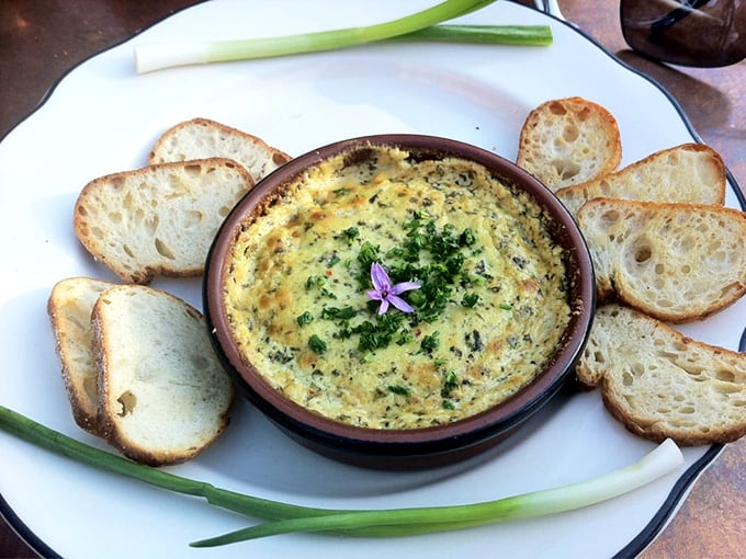 This isn't just a dip—it's a warm embrace in a ceramic bowl, surrounded by crusty bread soldiers ready for their delicious mission.