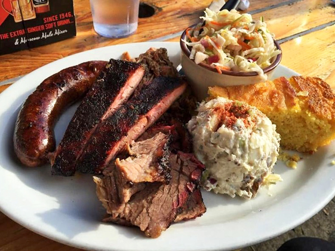 The carnivore's dream team: brisket with that telltale smoke ring, a sausage link that snaps just right, and sides that refuse to be overshadowed.