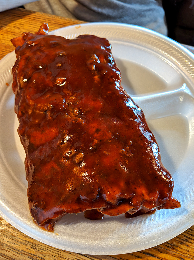 These ribs don't just fall off the bone—they practically leap into your mouth, glistening with that signature sauce that balances sweet and tang.