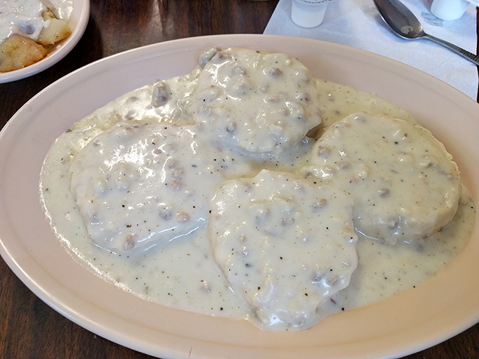 Biscuits swimming in a sea of peppery sausage gravy—not diet food, but soul food. The kind of breakfast that requires a nap by noon. 