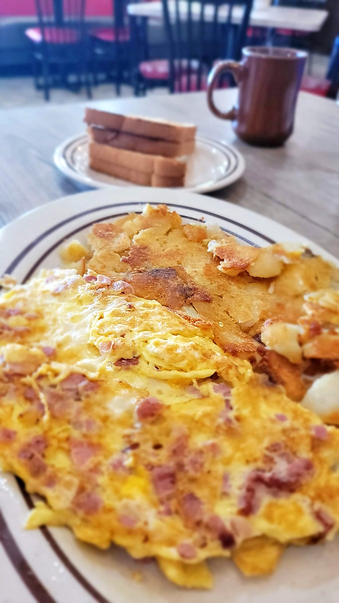Breakfast alchemy at its finest—golden eggs studded with ham meet perfectly crisped potatoes. This plate doesn't need a filter, just a fork.
