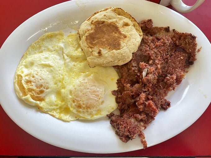 Sunny-side up eggs, a fluffy biscuit, and corned beef hash—the holy trinity of diner breakfasts done right.