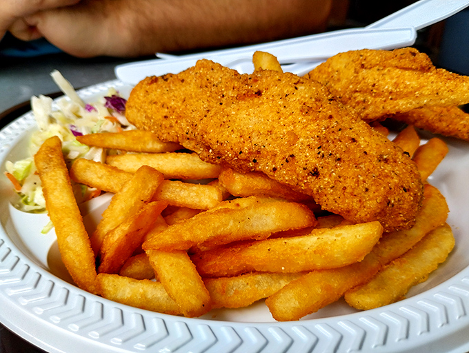 Golden-battered catfish that shatters with each bite, served with fries so perfect they make you question why you ever bothered with fancy food.