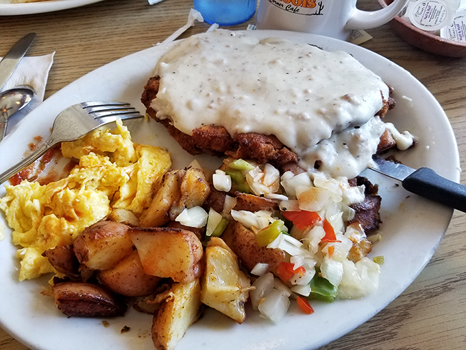 Behold the chicken fried steak in all its gravy-drenched glory—a masterpiece of comfort food that would make your cardiologist wince and your soul sing.