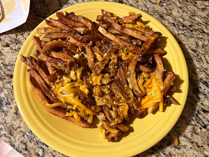 These aren't your average ballpark fries – they're a golden mountain of potato perfection smothered in melty cheese and savory chili.
