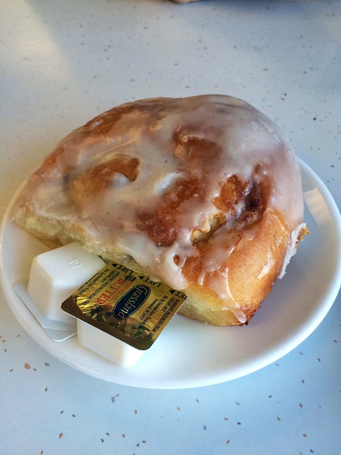 This cinnamon roll isn't just breakfast—it's dessert masquerading as a morning meal, with icing melting into every warm, cinnamon-spiced crevice.