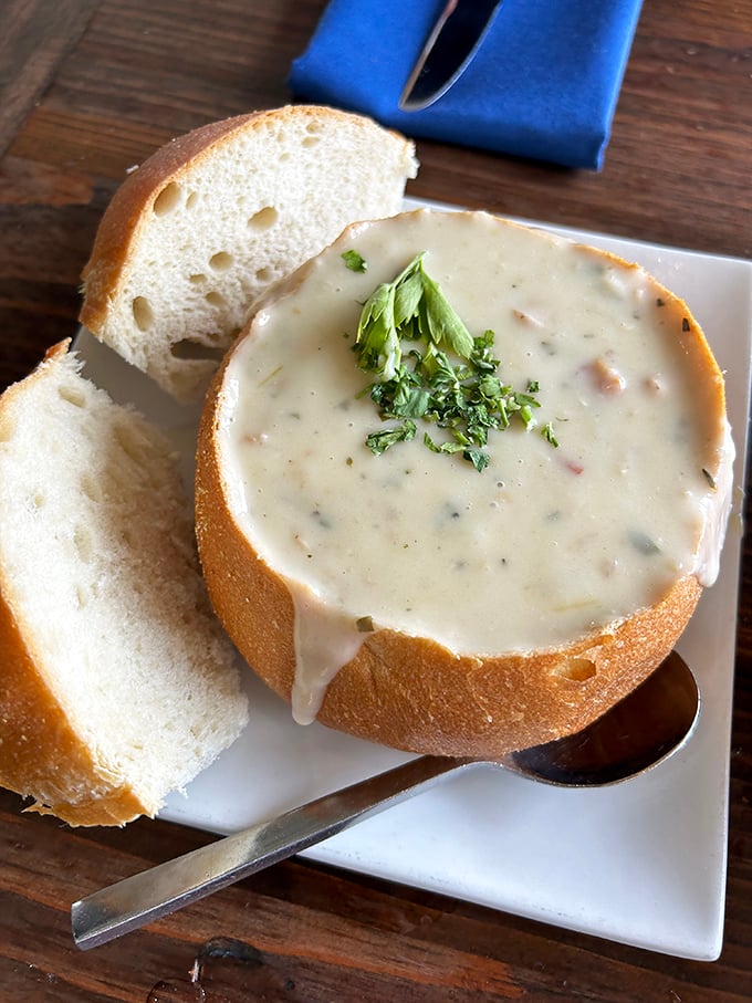 This isn't just clam chowder; it's a creamy revelation in a sourdough fortress. The fresh herbs on top aren't garnish—they're the crown jewels.