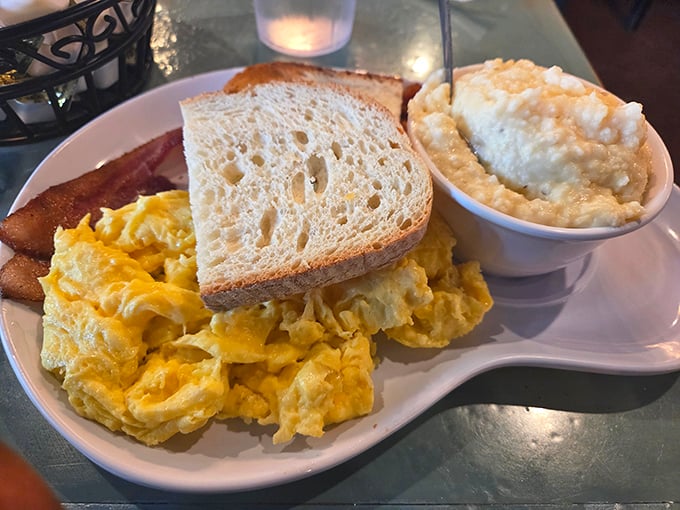 Scrambled eggs that look like clouds on a plate. This classic breakfast with toast and grits proves that sometimes the simplest combinations create the most profound satisfaction.