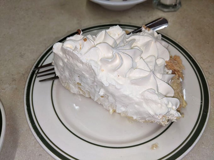 This coconut cream pie doesn't just have height—it has ambition. A cloud of meringue that makes other desserts look like they're not even trying.