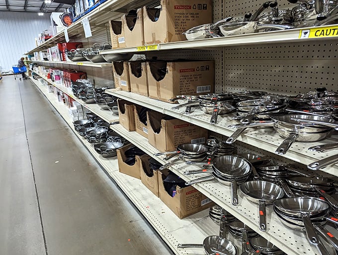 Pots and pans gleam under fluorescent lights like an armory for culinary warriors. Even professional chefs would pause here, contemplating the possibilities of discounted stainless steel.