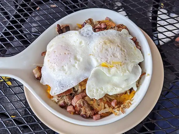 This isn't just corned beef hash—it's a masterpiece of crispy, savory perfection crowned with eggs that belong in a Renaissance painting.