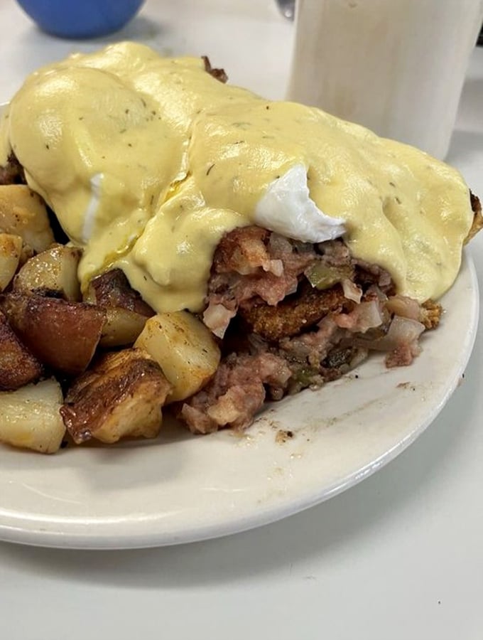 This isn't just corned beef hash – it's a mountain range of savory goodness with poached egg peaks and hollandaise lava flows. Explorers, bring your appetite.