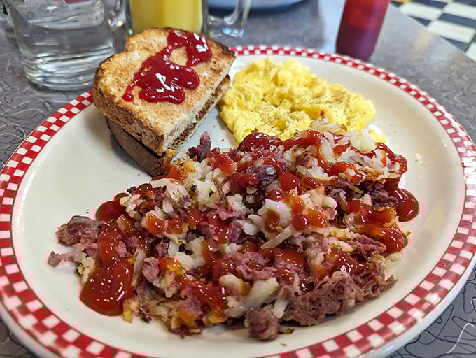 This isn't just corned beef hash – it's a masterpiece of savory comfort topped with enough hot sauce to make your morning interesting.