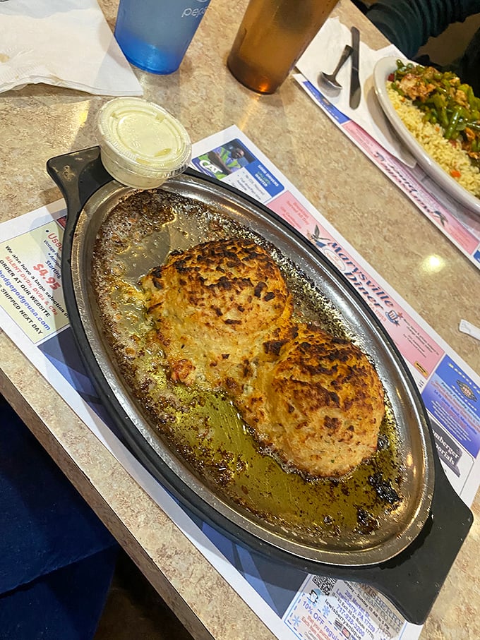 Golden-brown crab cakes sizzling in their own buttery glory—proof that breakfast can sometimes moonlight as a special occasion.