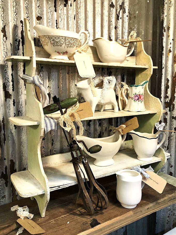 Grandmother's china cabinet comes to life with delicate gravy boats and vintage serving pieces, each tagged and waiting for their next dinner party.