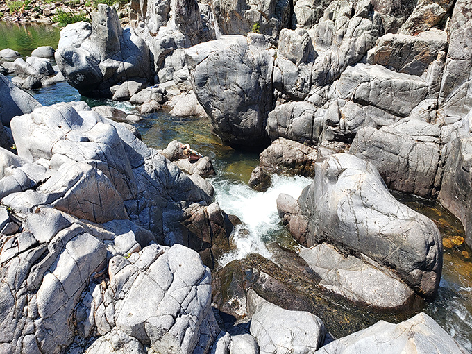 The Black River carving through volcanic rhyolite creates channels so perfect you'd swear someone designed them on purpose.