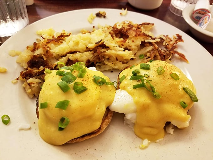 Behold the Benedict that launched a thousand brunch trips—golden hollandaise cascading over perfectly poached eggs like sunrise over the Great Lakes.