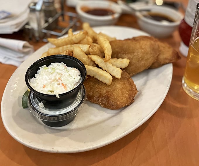 Golden-battered fish that shatters with each bite, alongside fries that achieve the perfect crisp-to-fluffy ratio. This isn't just dinner—it's edible therapy.