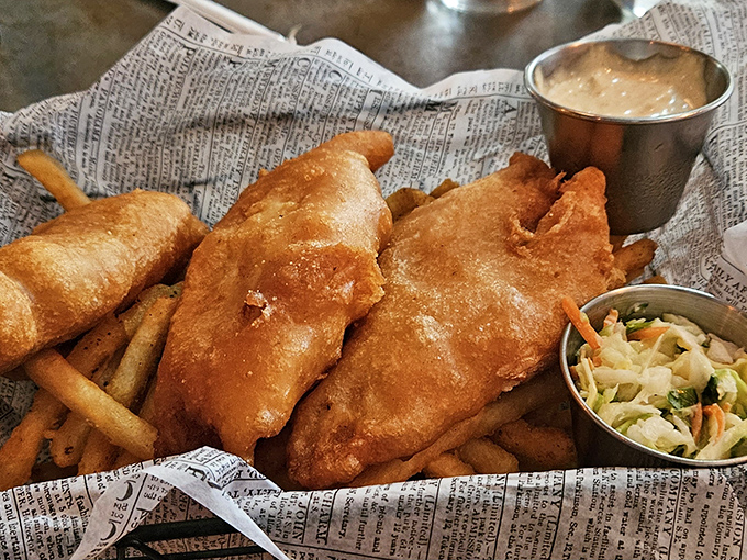 Fish and chips that would make a British pub jealous, served on newspaper because some traditions are worth keeping.