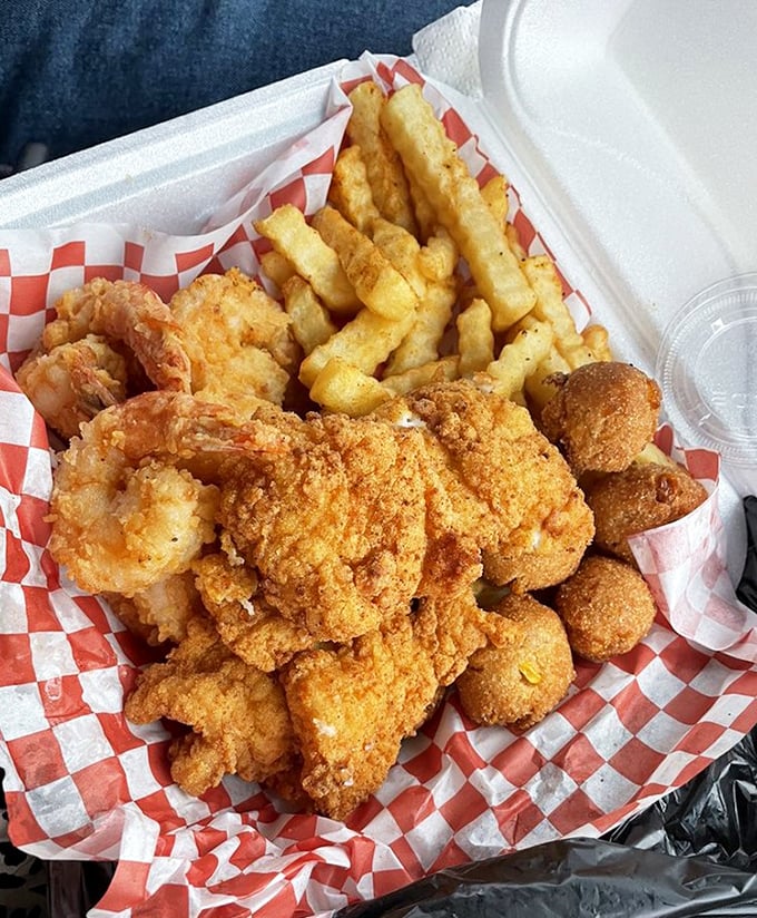 Fried to golden perfection, this seafood basket doesn't just feed you—it hugs your soul. The crinkle-cut fries are merely supporting actors to the star shellfish. 