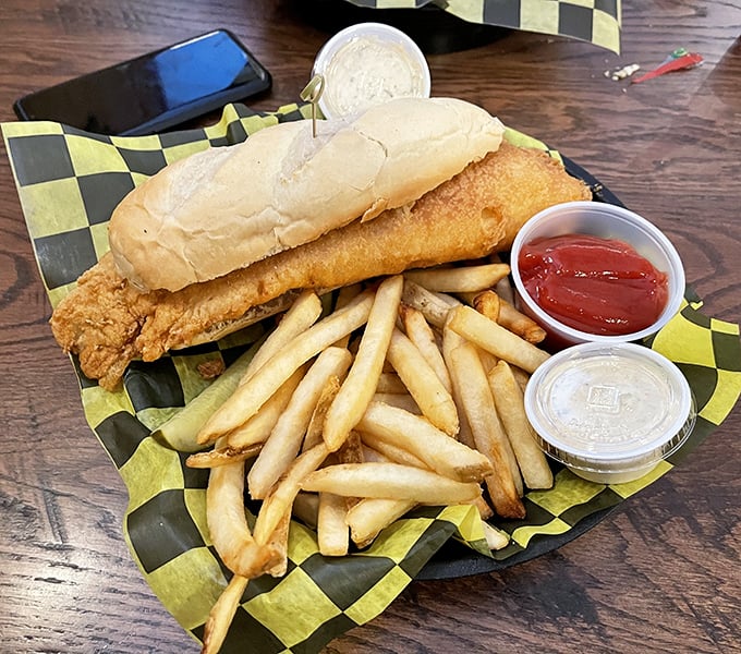 Behold the star of the show! This golden-fried fish sandwich with crispy fries isn't just a meal—it's the reason cyclists pedal extra miles.
