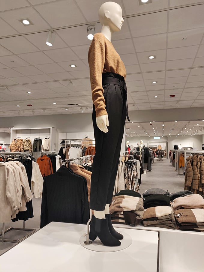 Mannequins sporting fall's finest—because nothing says "I've got my life together" quite like perfectly tailored wide-leg trousers and a camel sweater.