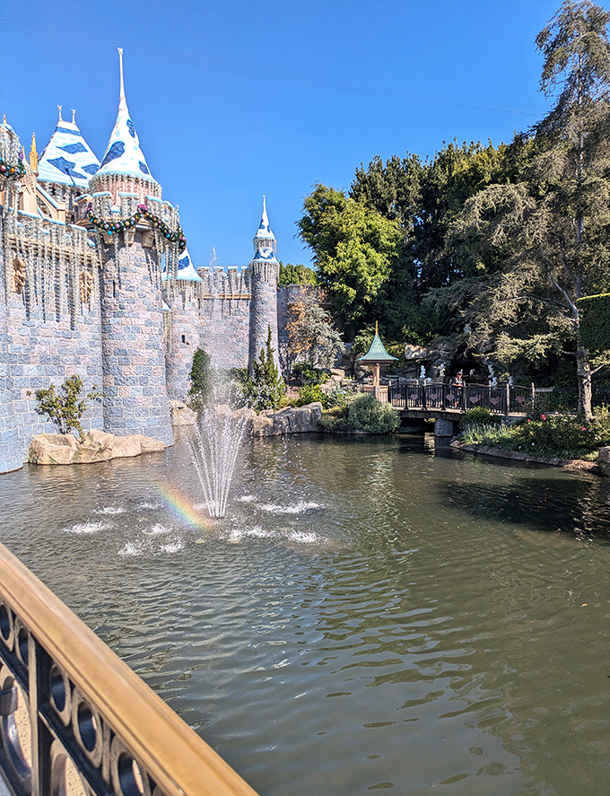 The castle moat reflects centuries of fairy tales, while a rainbow dances in the fountain spray—nature's own special effect.