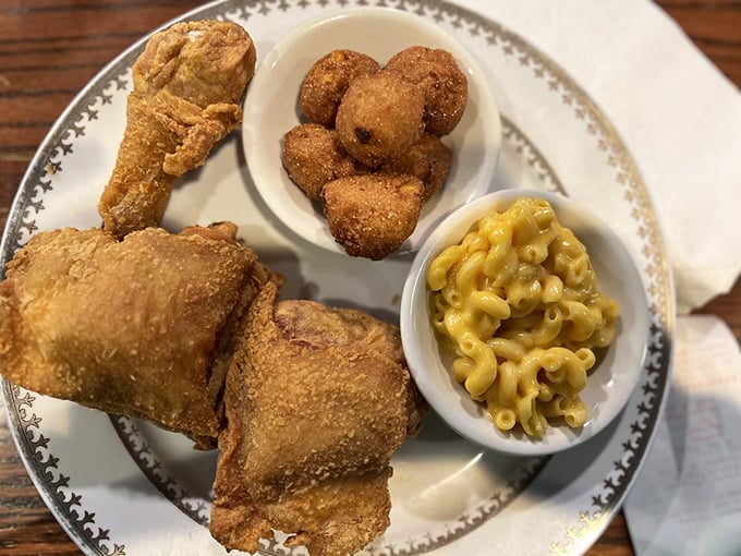 Golden-brown fried chicken that makes a satisfying crunch you can practically hear through the photo. Paired with hushpuppies and mac & cheese—the holy trinity.