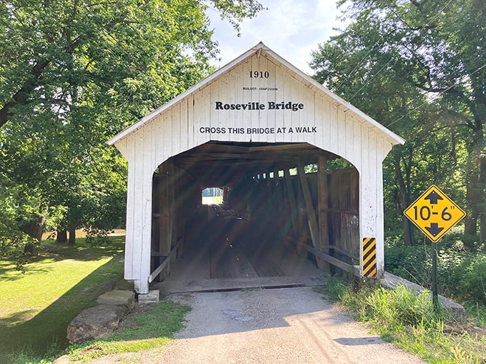 White trim, red walls, and a tunnel through time—covered bridges are basically barns with better views.