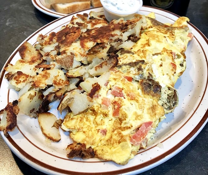 Breakfast alchemy at its finest—golden eggs cradling savory fillings alongside perfectly crisped potatoes. The breakfast of champions who aren't training for anything.