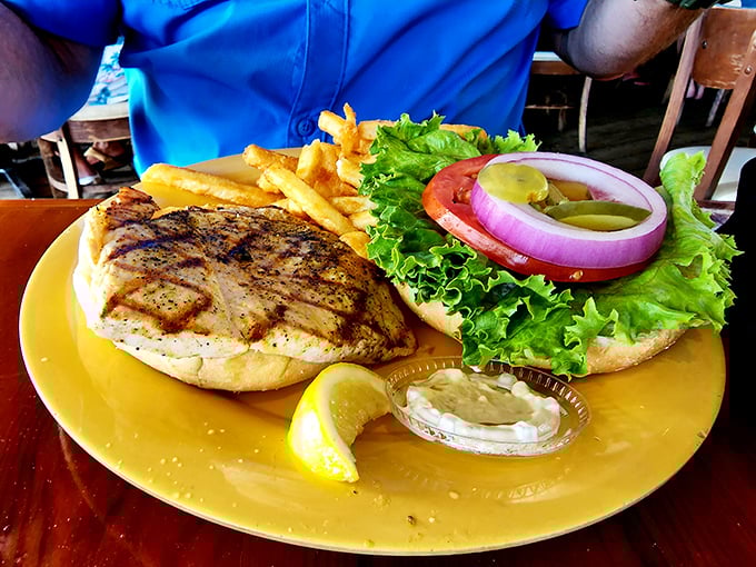 Behold, the star of our show! The grilled grouper sandwich arrives with all the fanfare it deserves—fresh, flaky, and flanked by crispy fries.