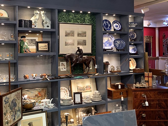 Blue-gray shelves create the perfect stage for porcelain performers, equestrian bronzes, and delicate china that's survived longer than most marriages.