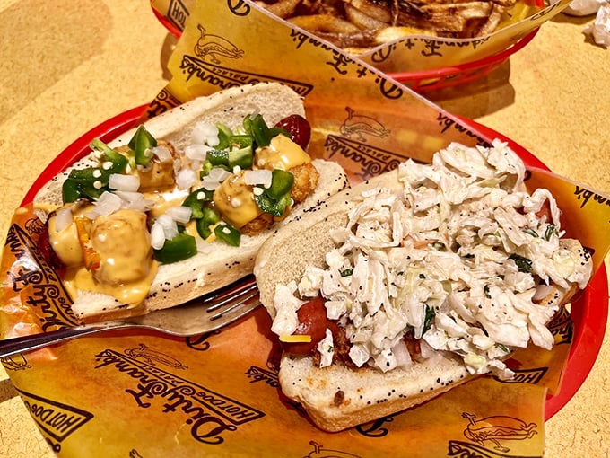 Two dogs, two different worlds of flavor. Like the Odd Couple of frankfurters—completely different personalities but somehow perfect roommates on that red plate.