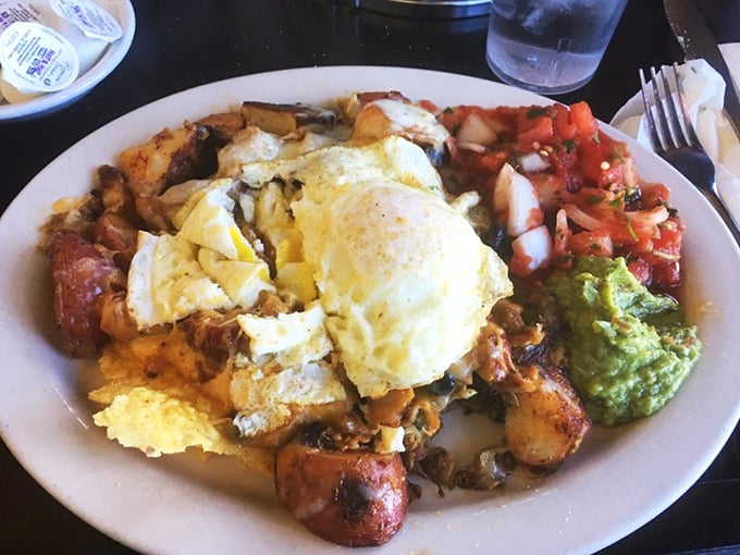 This isn't just breakfast, it's edible architecture – layers of flavor with eggs as the crowning glory and salsa as the colorful foundation.