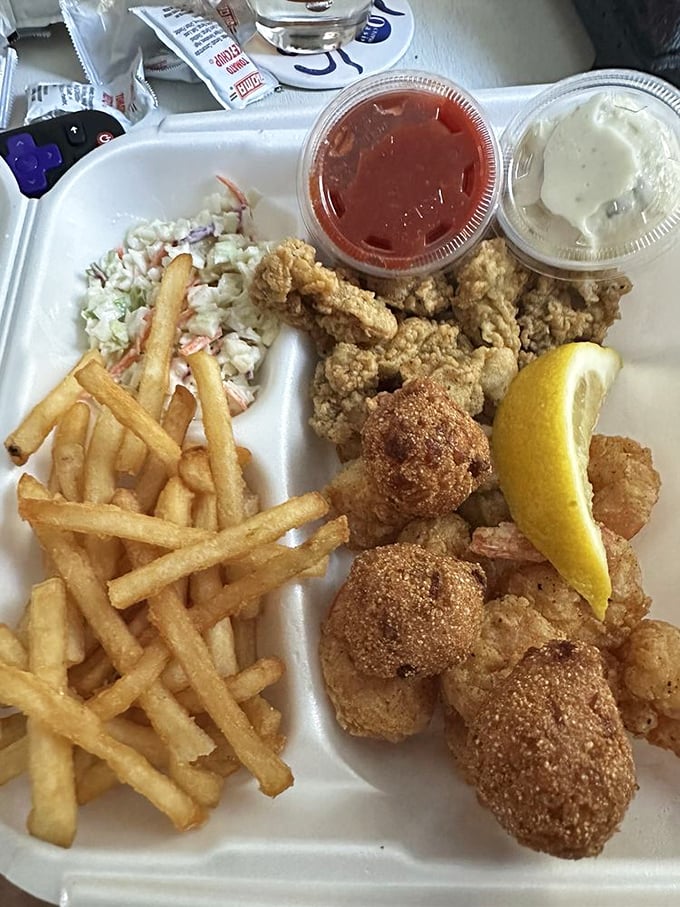 Golden-fried perfection that would make Neptune himself swim to shore. Those hush puppies aren't just side dishes—they're little spheres of Southern happiness.