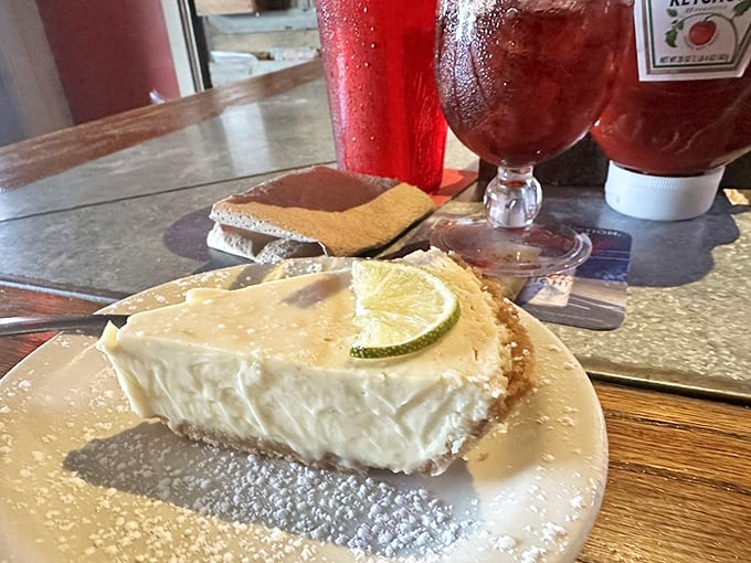 This key lime pie doesn't whisper Florida, it belts out sunshine with every creamy, tangy bite. The powdered sugar snowfall is pure midwestern hospitality.