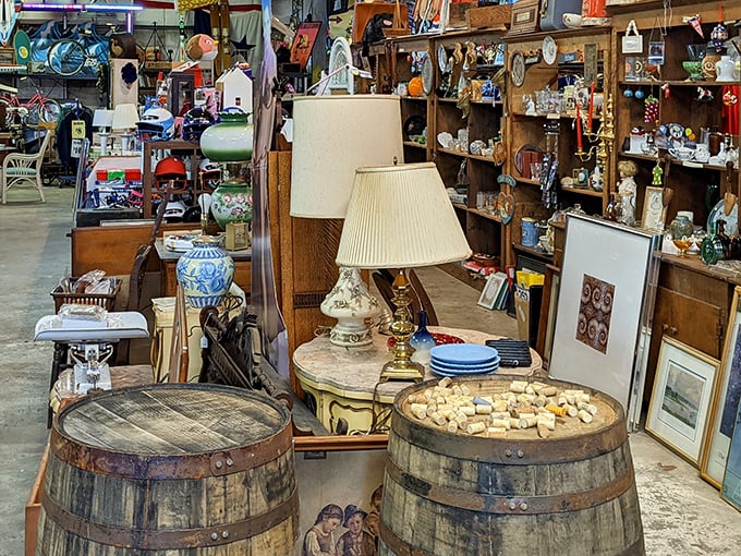 Wooden barrels repurposed as display tables showcase vintage lamps and porcelain treasures—proving everything here deserves its second act.