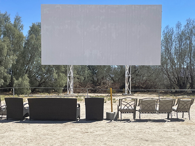 Desert ingenuity at its finest—patio furniture arranged for the ultimate outdoor screening experience under the stars.