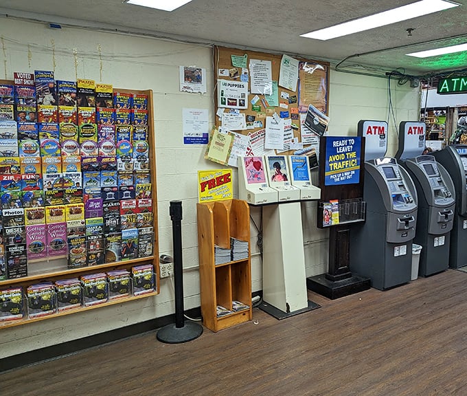 The modern oasis within the market—ATMs stand guard beside brochures advertising local attractions and adventures.