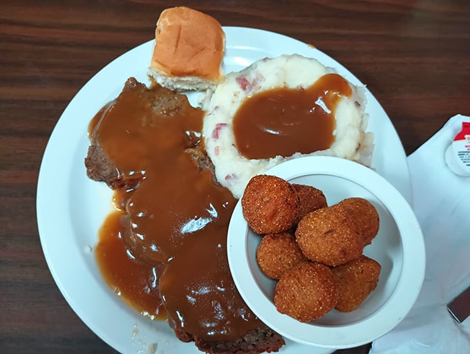 That meatloaf could make your grandmother jealous—swimming in gravy like it owns the pool.