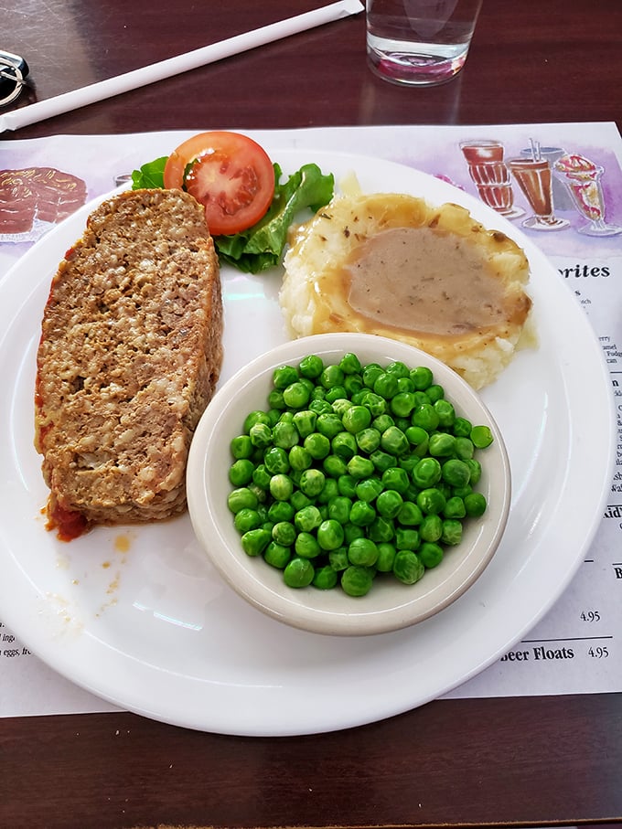 Behold the holy grail of comfort food! This meatloaf doesn't just sit on the plate—it commands respect with its perfect crust.