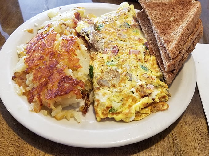 This isn't just an omelet—it's a morning masterpiece with perfectly crisped hash browns and toast that makes you question all other toast you've encountered.