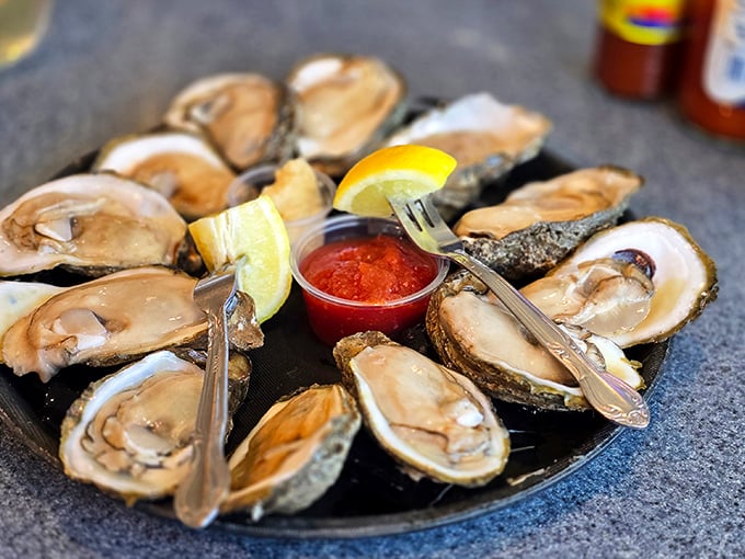 These oysters aren't just served—they're presented like the coastal jewels they are, with lemon crowns and cocktail sauce rubies.