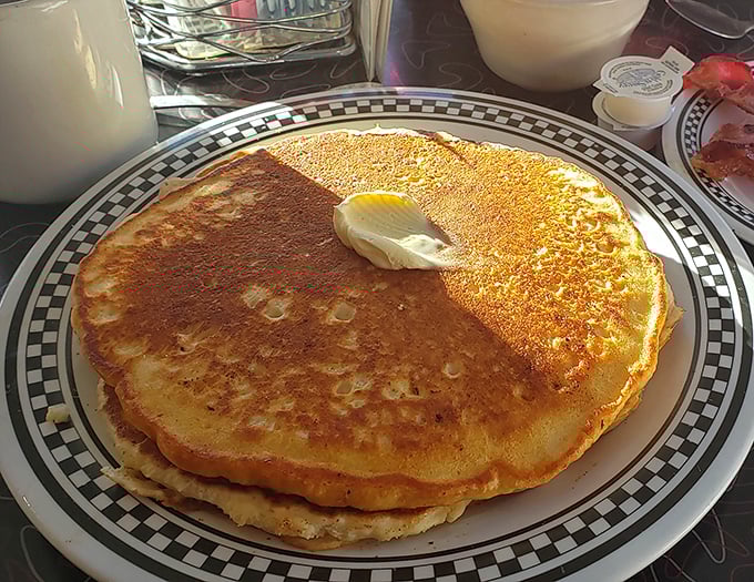 These golden pancakes aren't just breakfast—they're edible sunshine on a plate, waiting for that perfect butter melt.