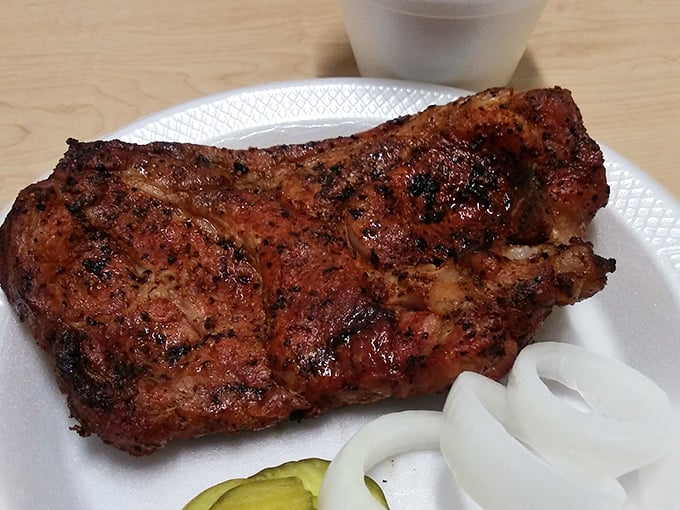 Behold the pork steak in all its glory – a mahogany-crusted masterpiece with a pink smoke ring that would make a jeweler jealous.