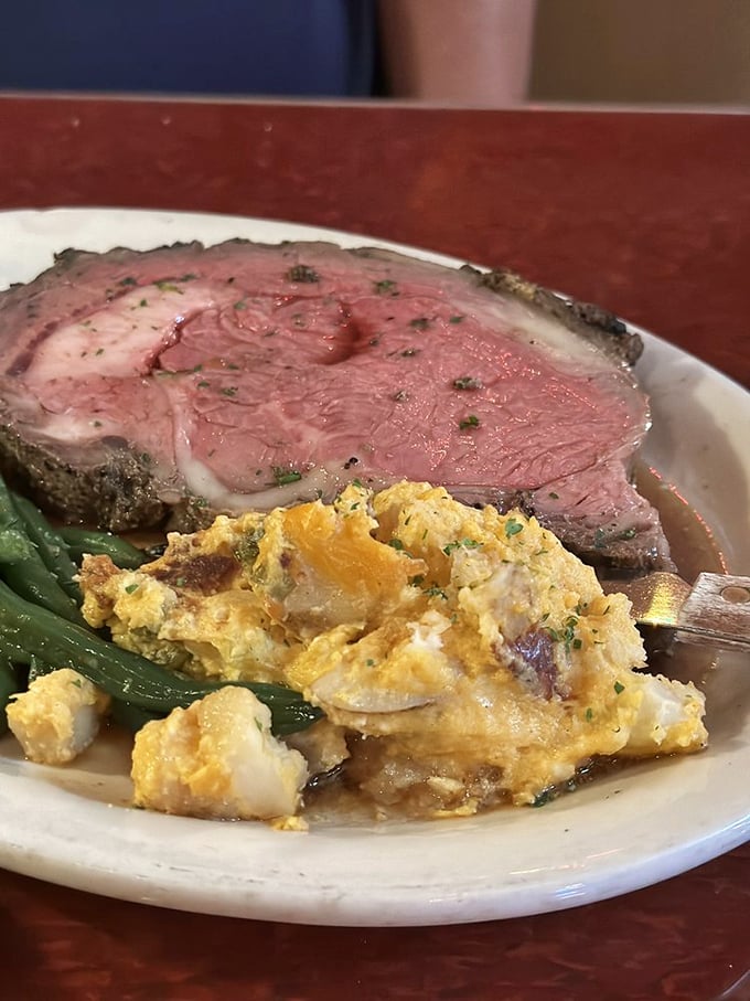 The prime rib arrives like a carnivore's dream—perfectly pink, seasoned with reverence, and accompanied by sides that know their supporting role.